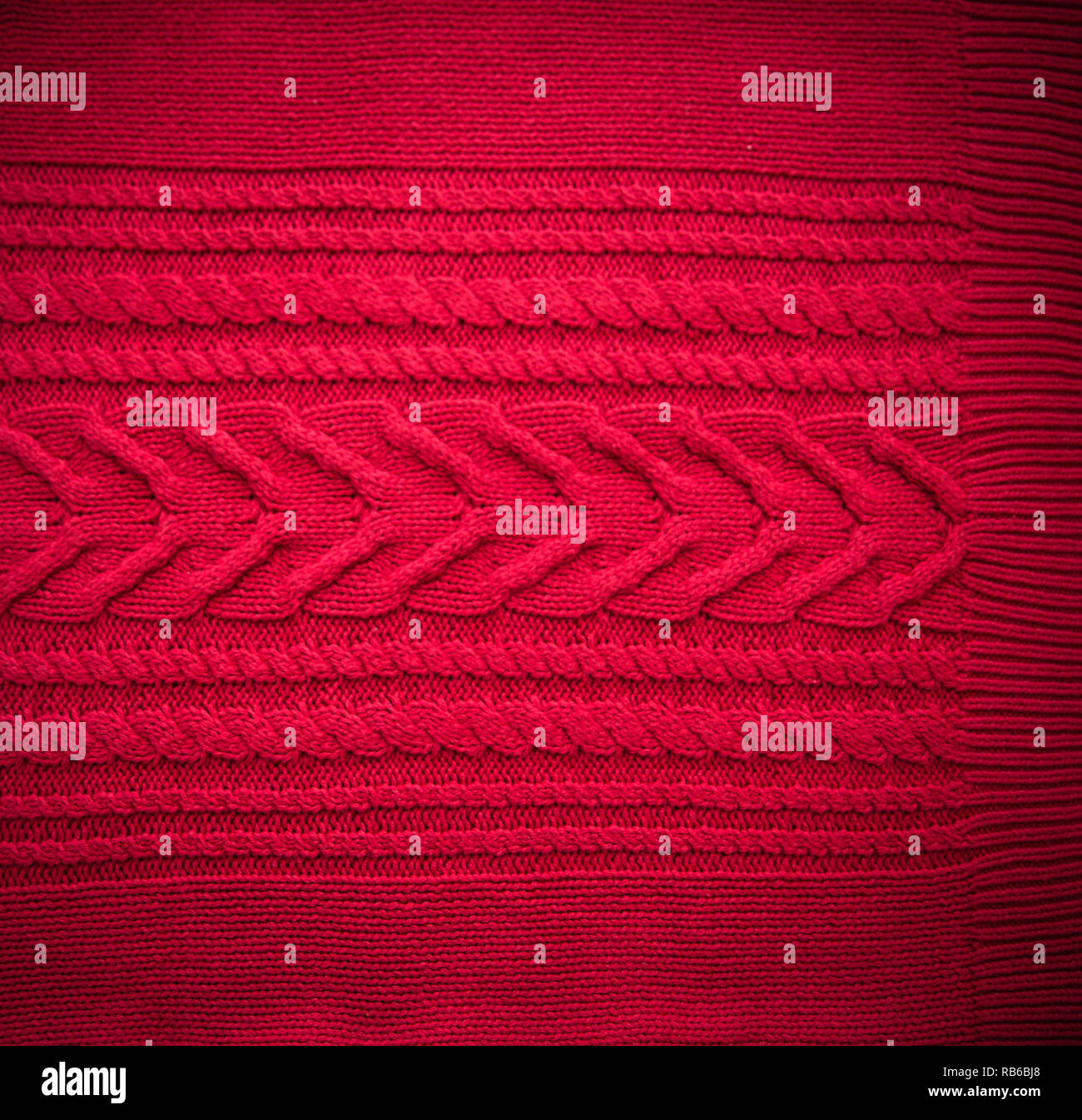 Red Knitted pattern wool sweater texture close up. Handmade red ...