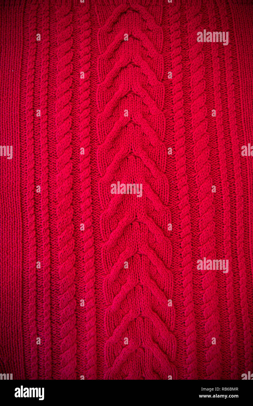 Red Knitted pattern wool sweater texture close up. Handmade red ...
