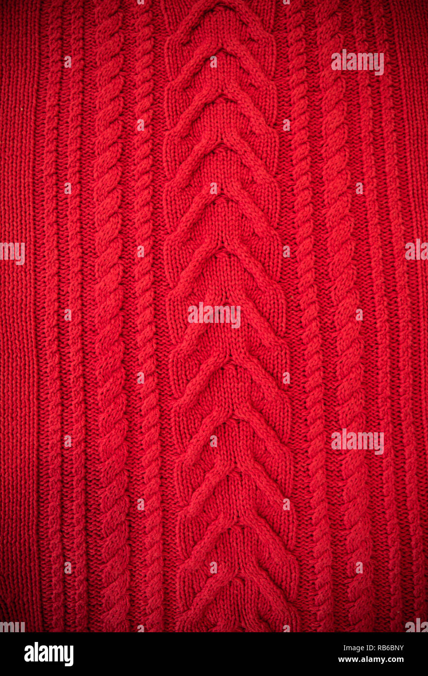 Red Knitted pattern wool sweater texture close up. Handmade red ...