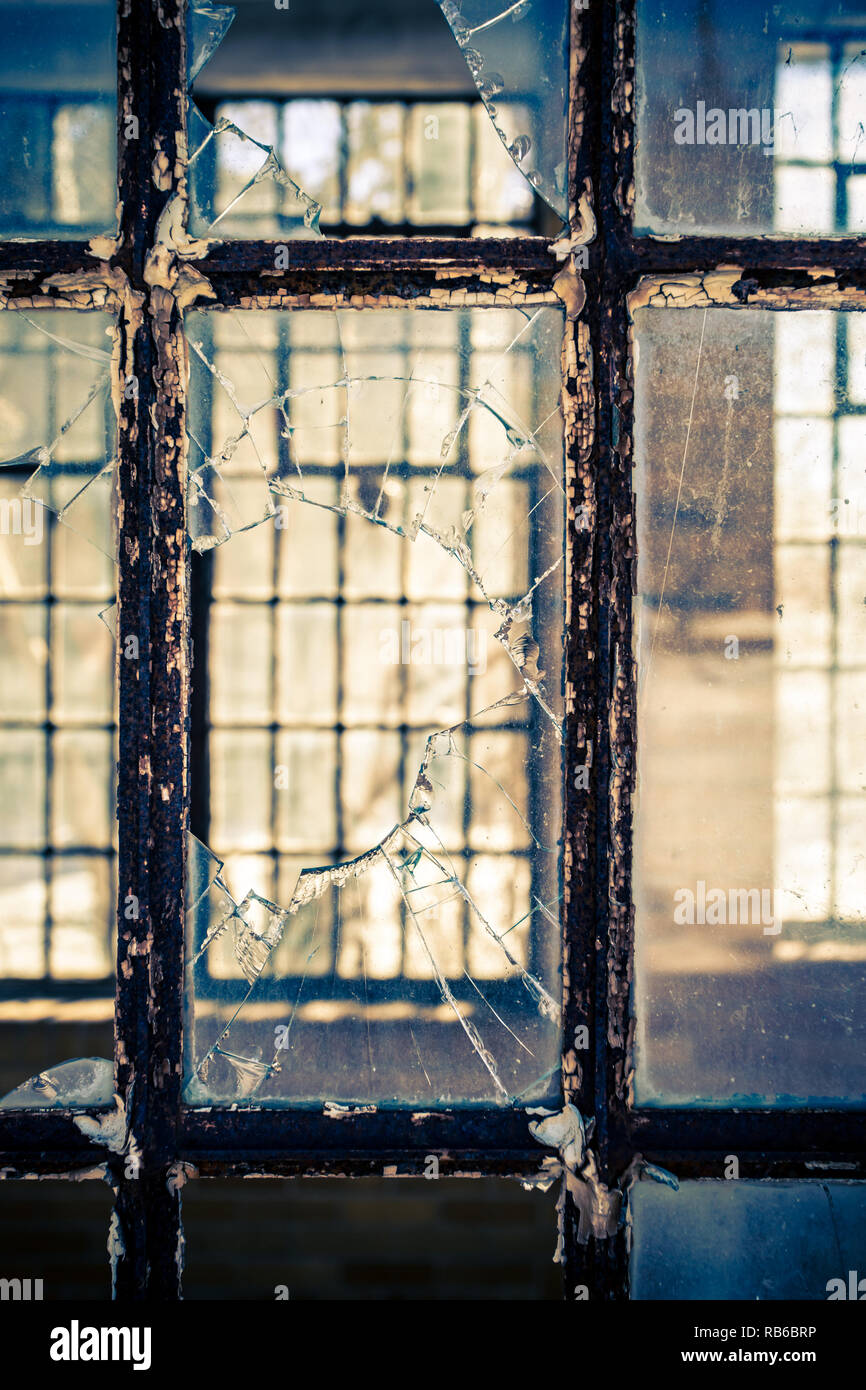Broken glass windows from abandoned hospital building Stock Photo - Alamy