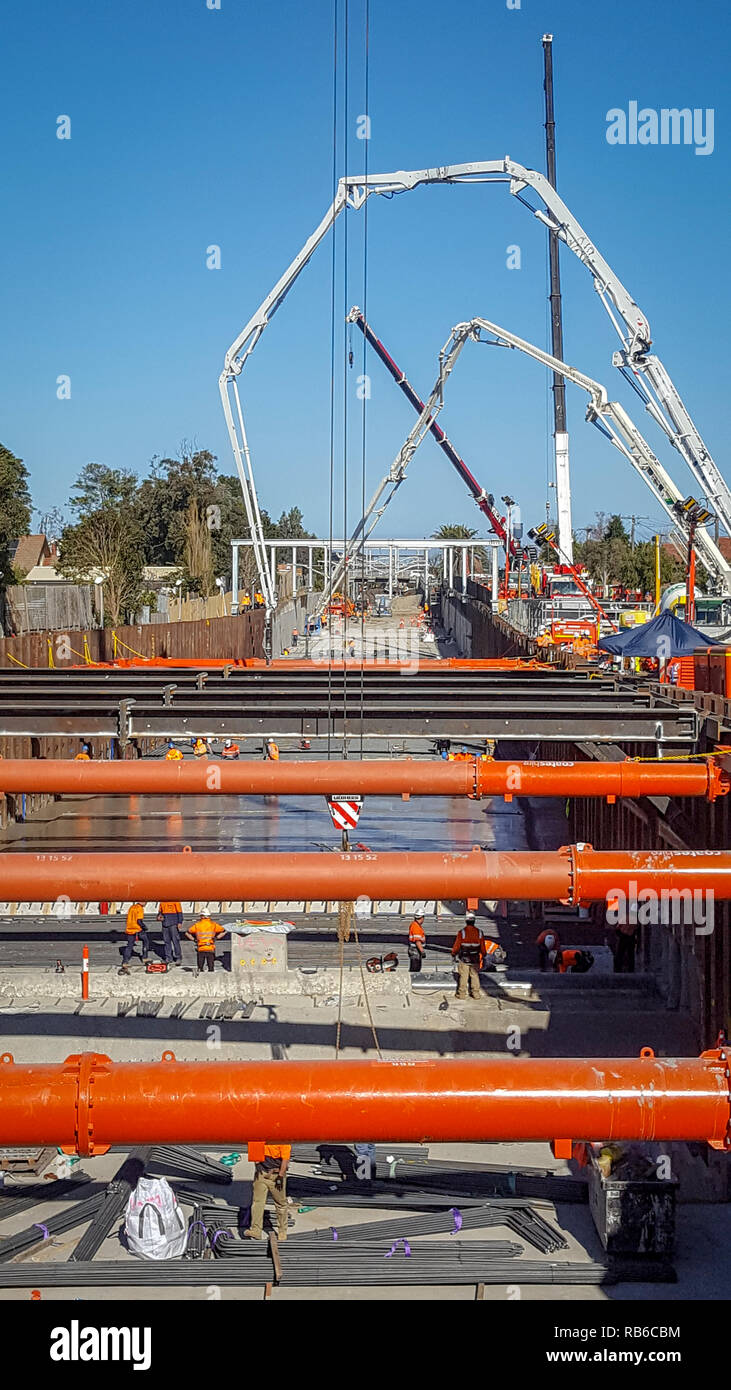 Work site with concrete pumping equipment building a train station ...