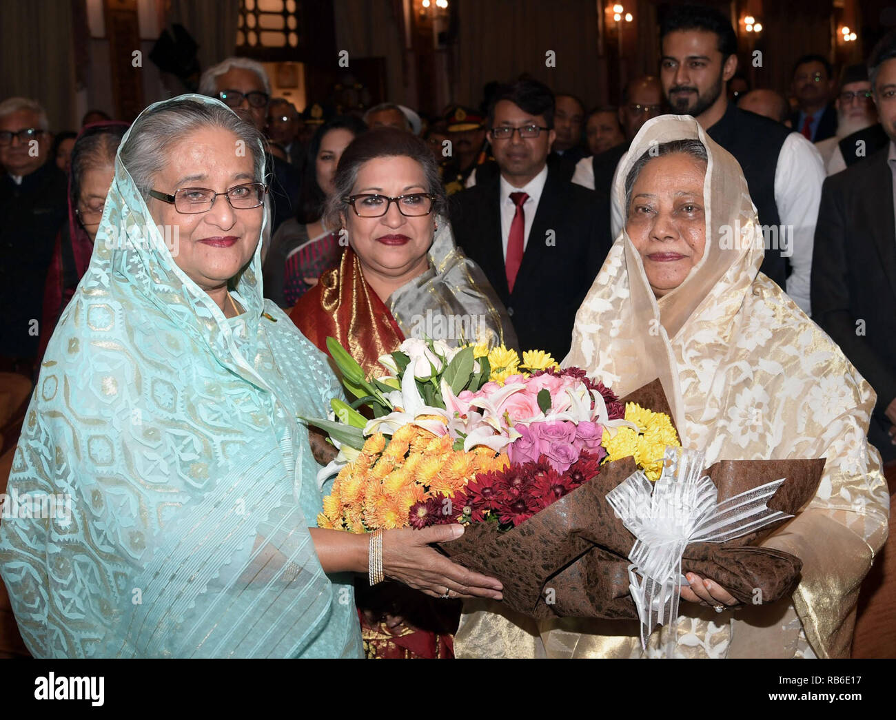 Dhaka. 7th Jan, 2019. Sheikh Hasina (L) receives a bouquet after taking oath as the Prime ...