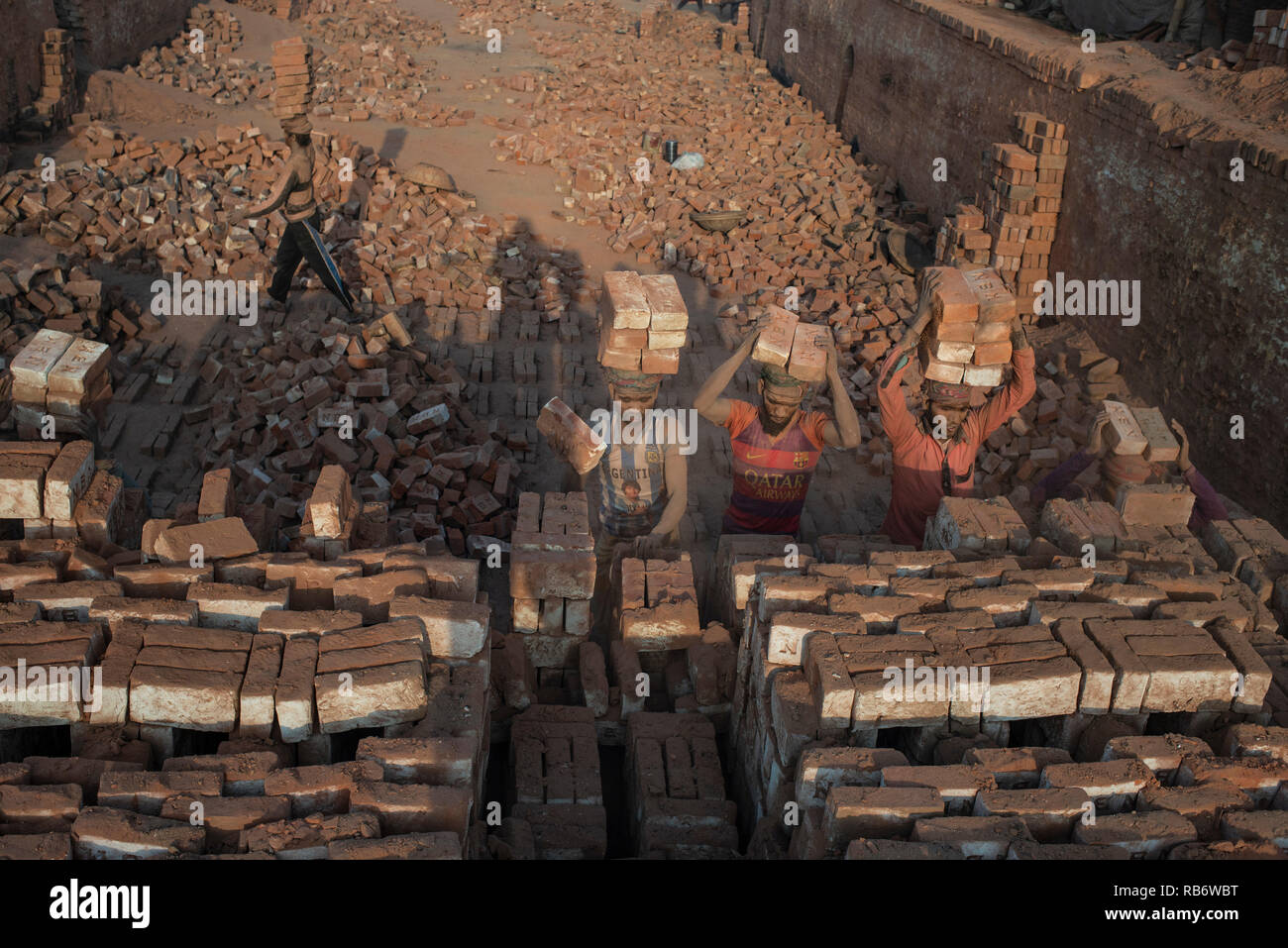 Brick field workers seen working in extreme dust. Though demand for ...