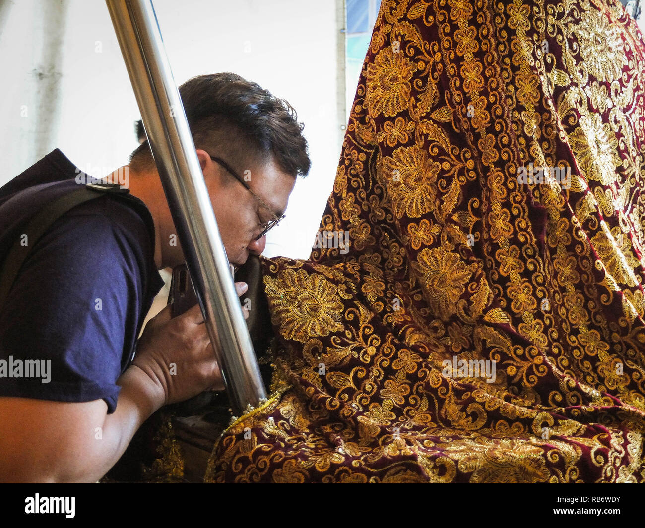 A male devotee seen kissing the feet of the Black Nazarene replica ...