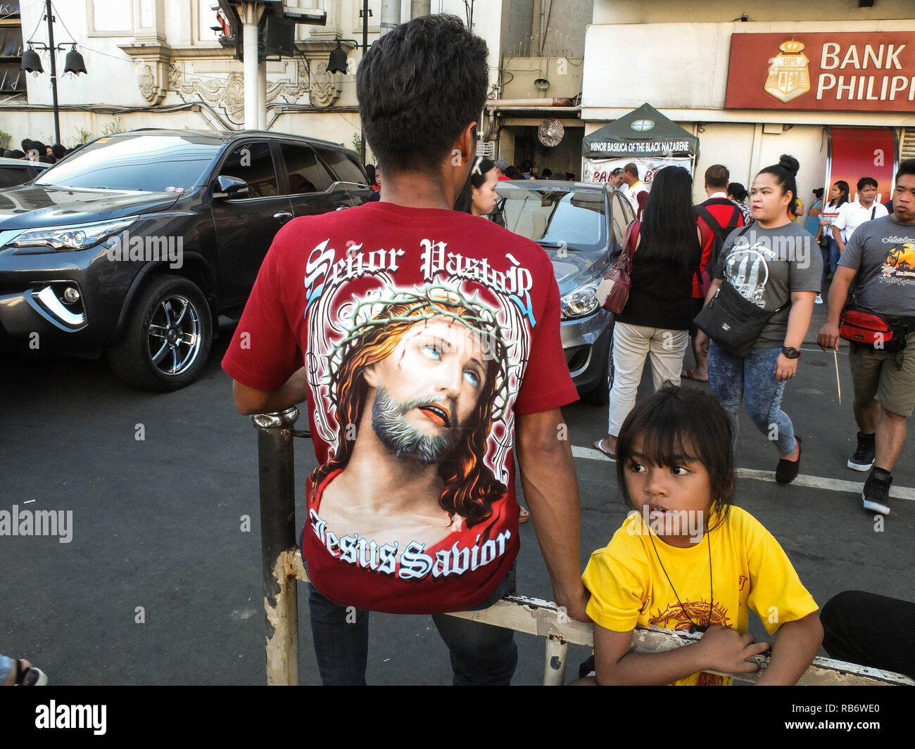 A father and her daughter are seen wearing Black Nazarene T-shirts ...