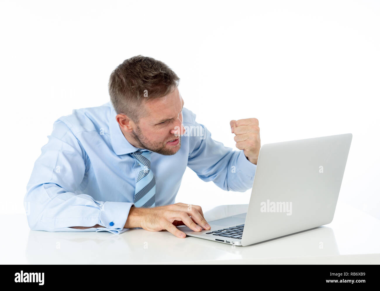 Stressed entrepreneur businessman with laptop computer at office desk ...