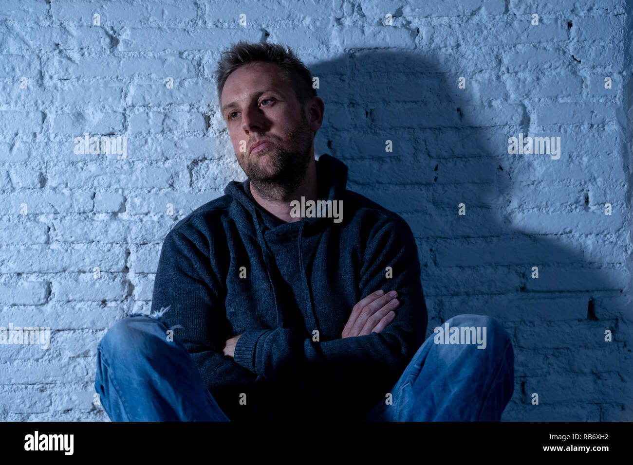 Young devastated depressed man crying sad feeling hurt suffering ...