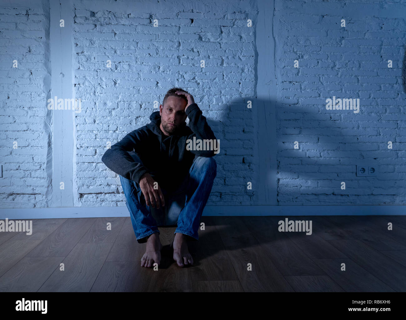 Young devastated depressed man crying sad feeling hurt suffering ...