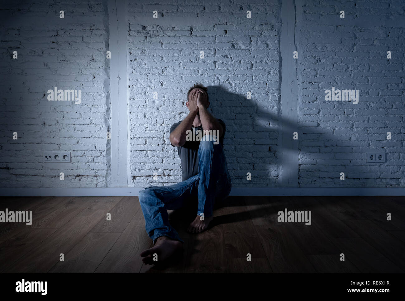 Young devastated depressed man crying sad feeling hurt suffering ...