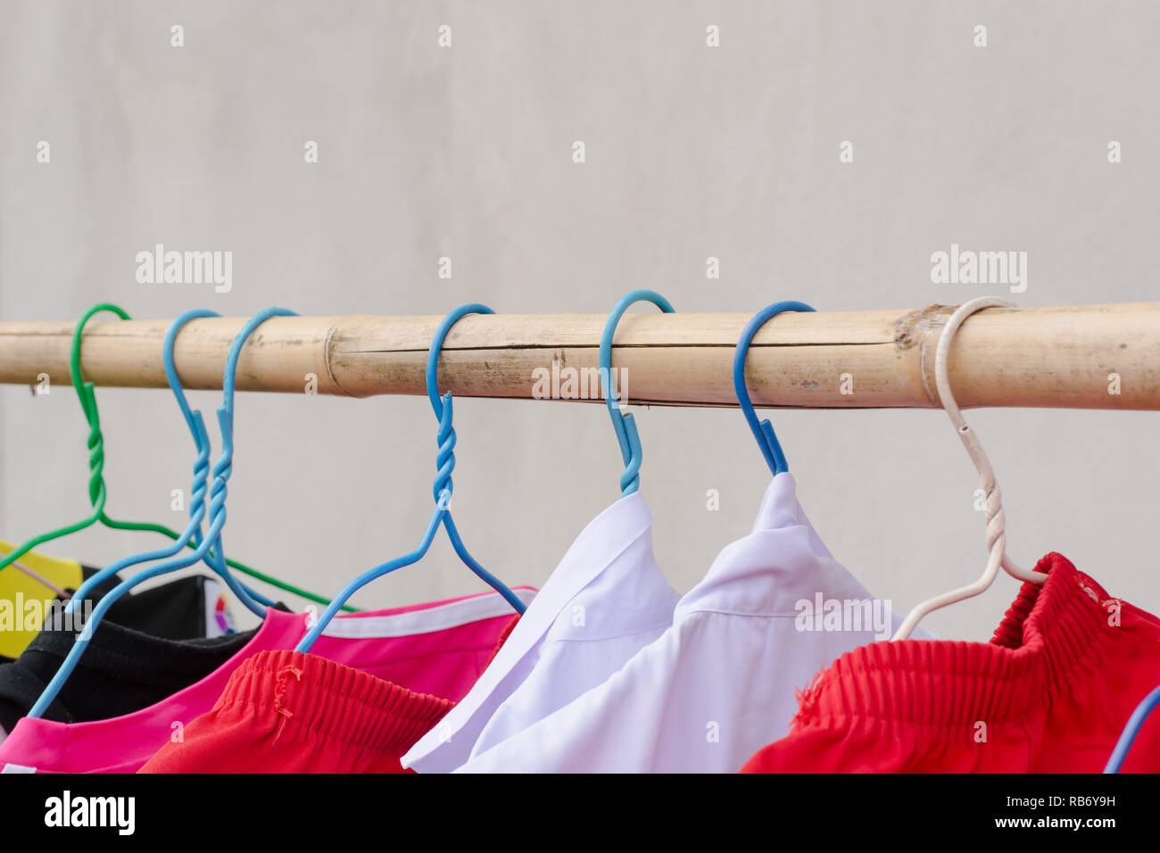 Drying clothes by using bamboo clothesline Stock Photo - Alamy