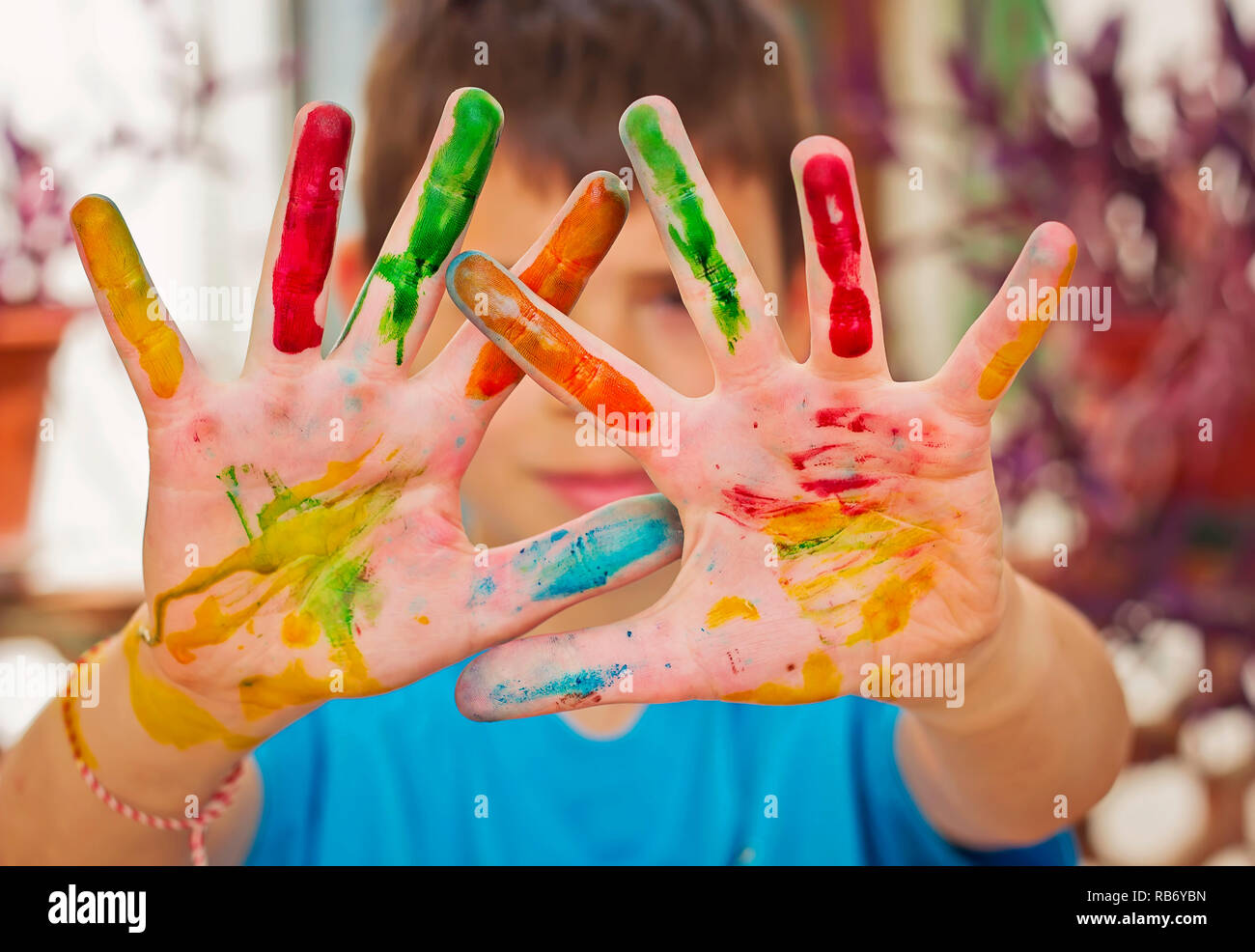 Child with fingers painted in different colors Stock Photo - Alamy