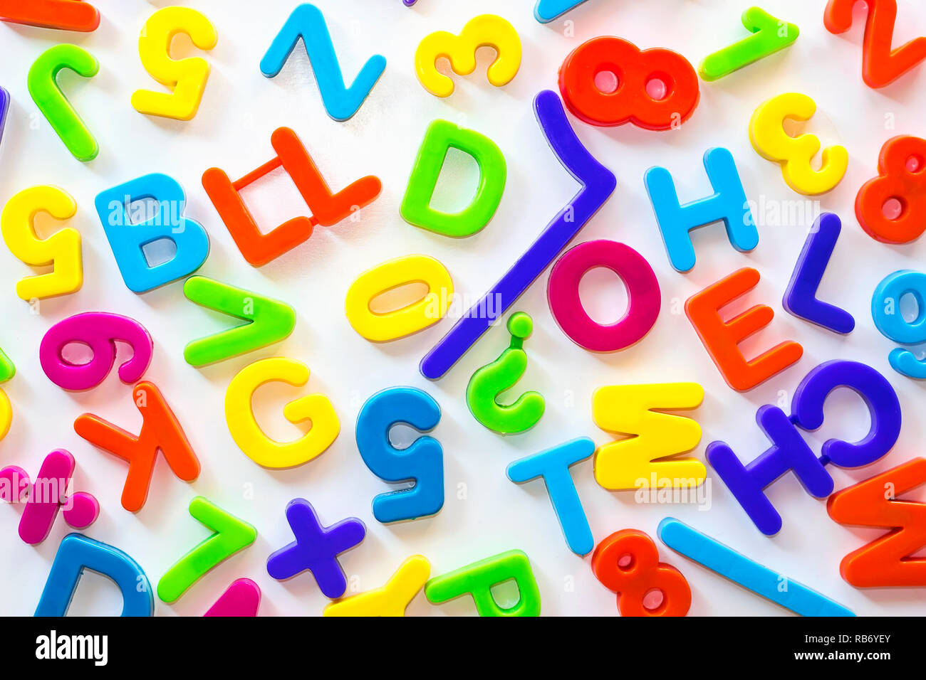 Letters and numbers of different colors on white surface Stock Photo ...