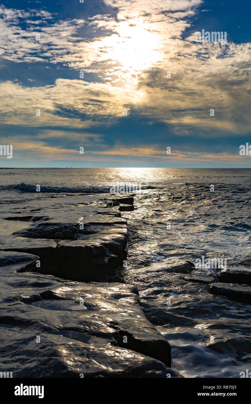 Landscape photograph in portrait orientation of a wet washing ledge ...