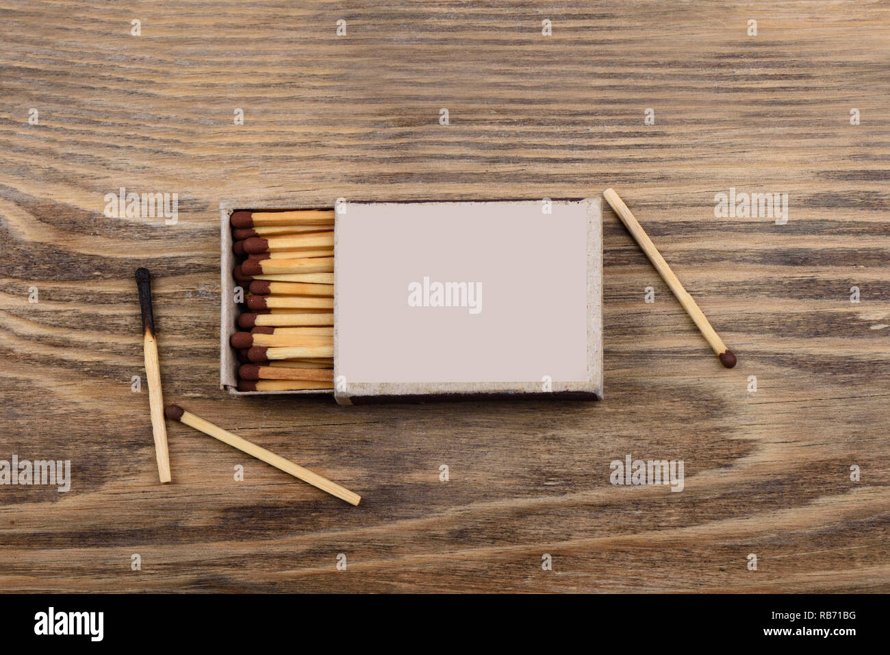 Matches with brown gray in a matchbox on a wooden table. Rustic style ...