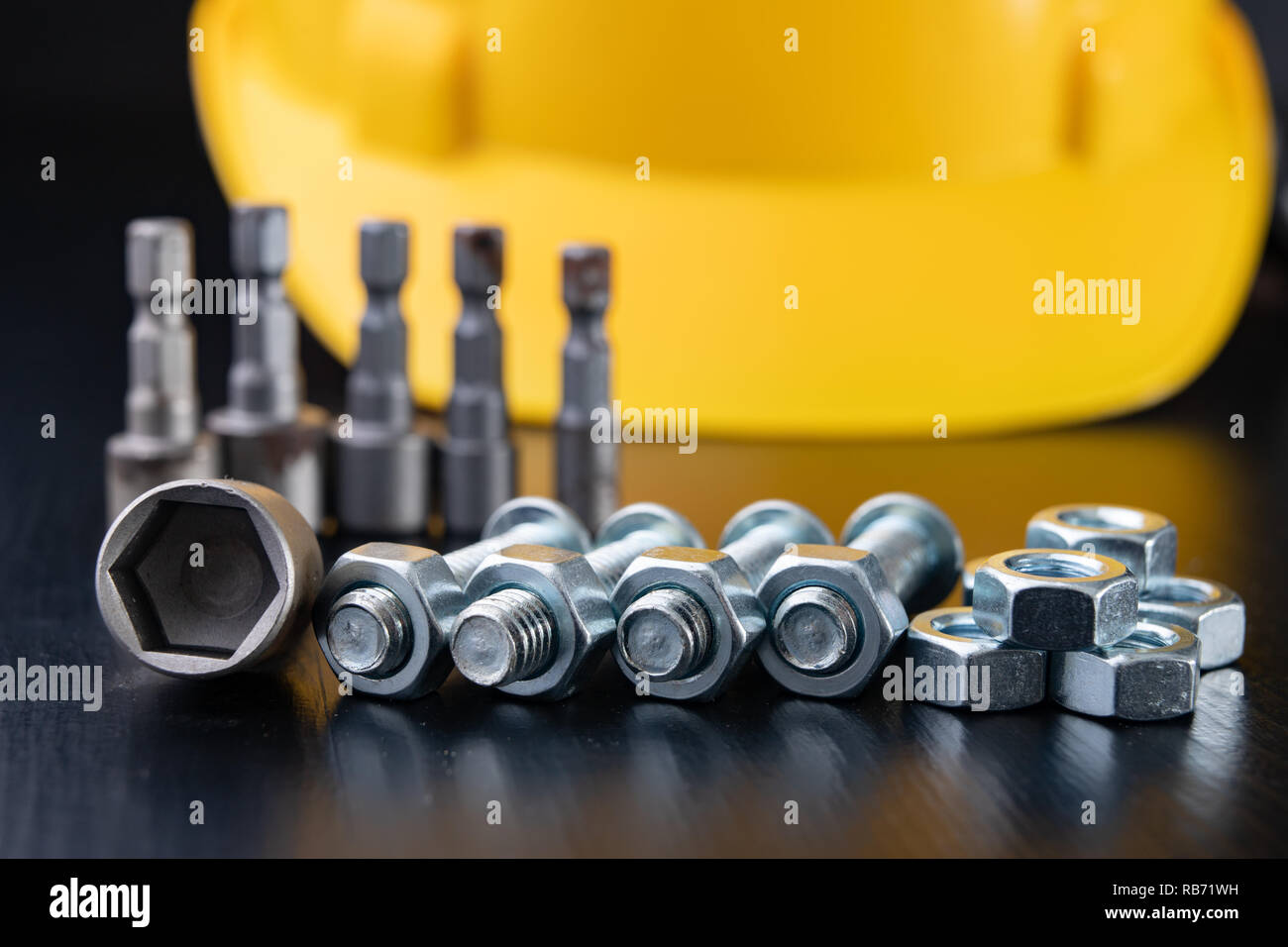 Screws, nuts and keys on a workshop table. Tools and accessories for ...