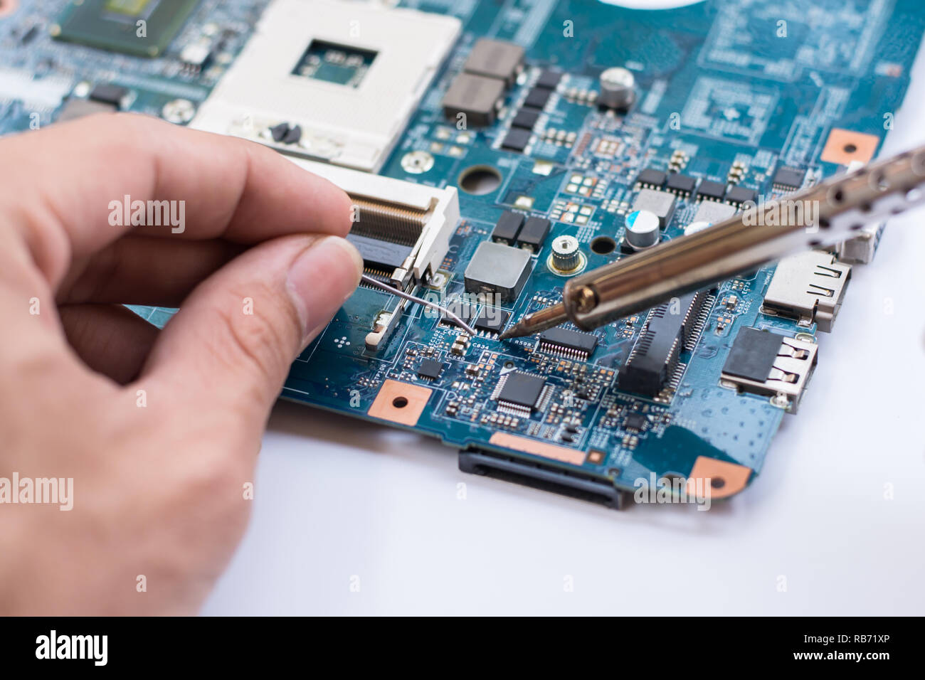 Repair of electronic devices, tin soldering parts Stock Photo - Alamy