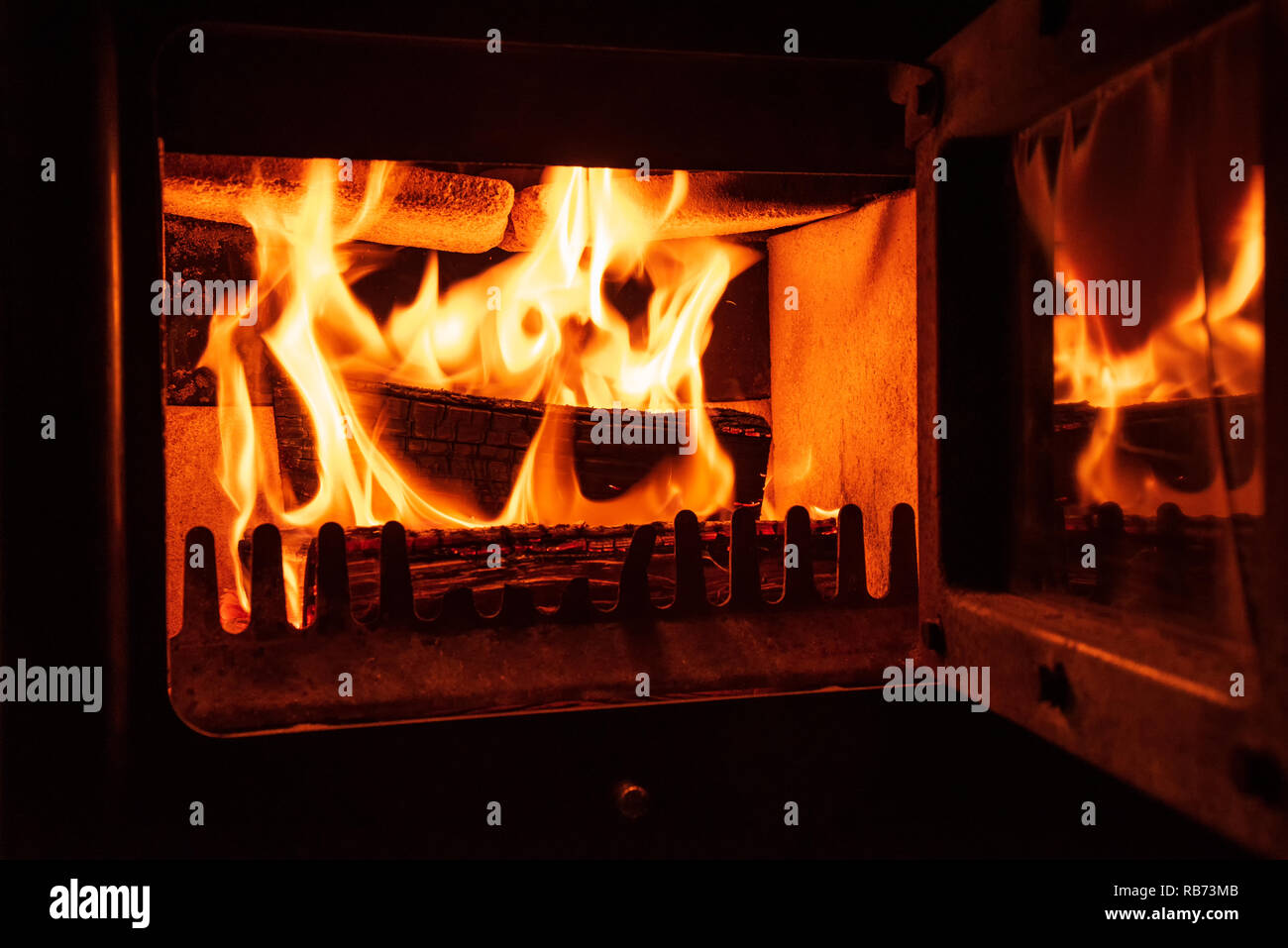 wood logs burning in a wodd stove home fire Stock Photo - Alamy