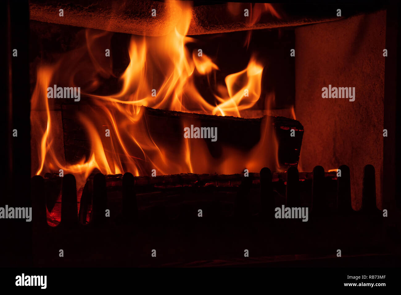 wood logs burning in a wodd stove home fire Stock Photo - Alamy