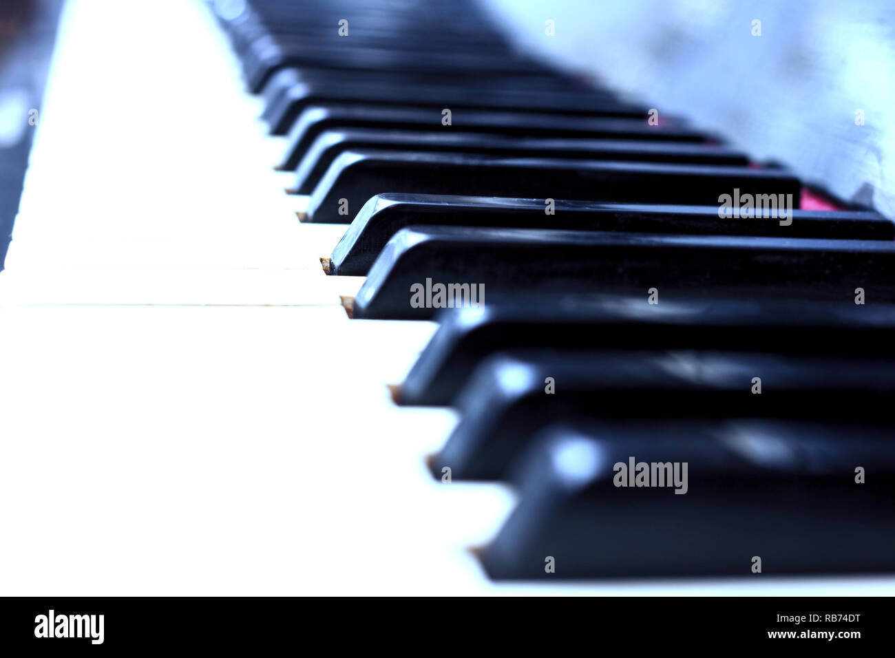 Close up piano keys black and white in light blue sepia Stock Photo - Alamy