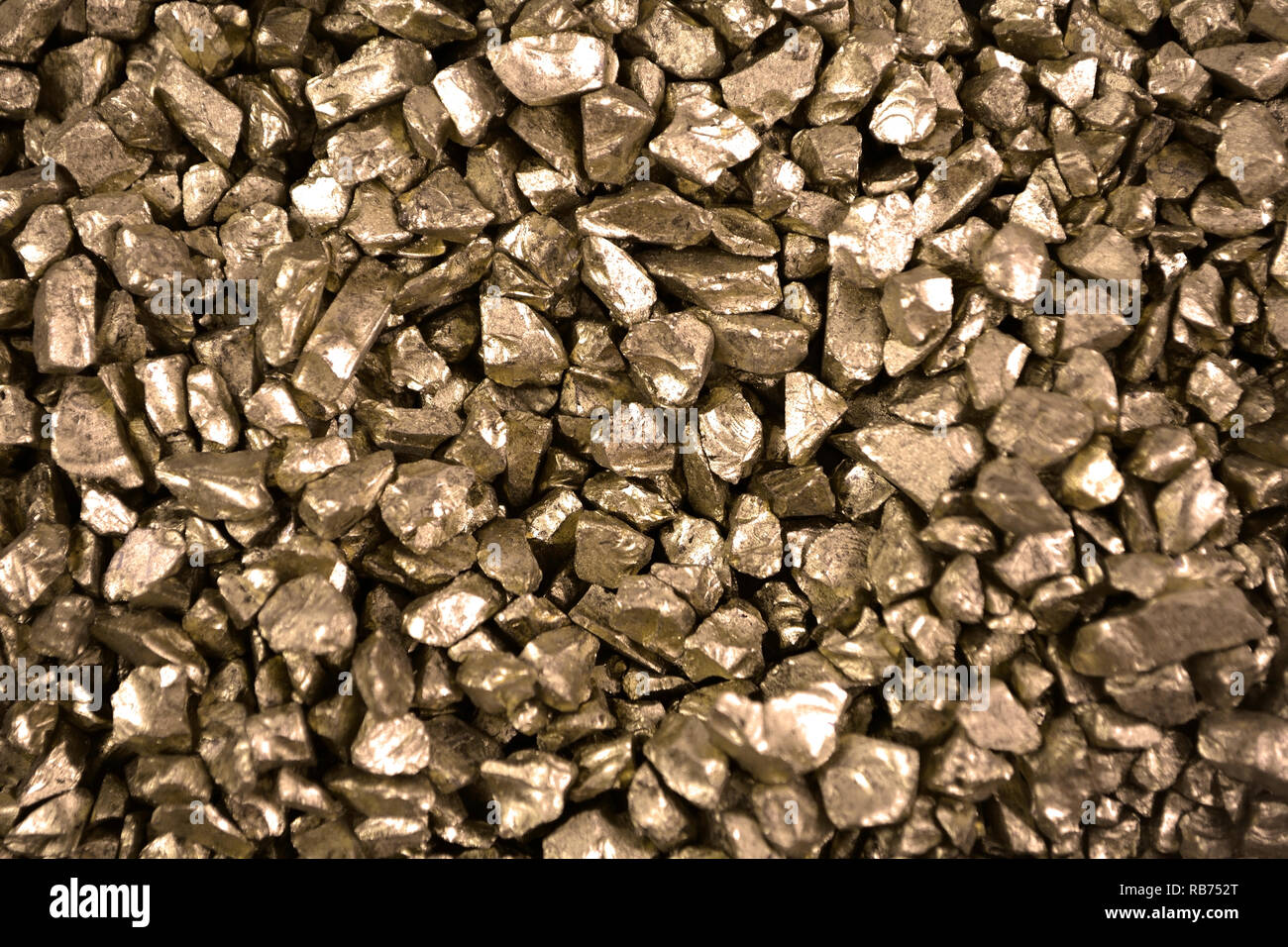 Mound of gold sand close-up black background, gold nuggets stones ...