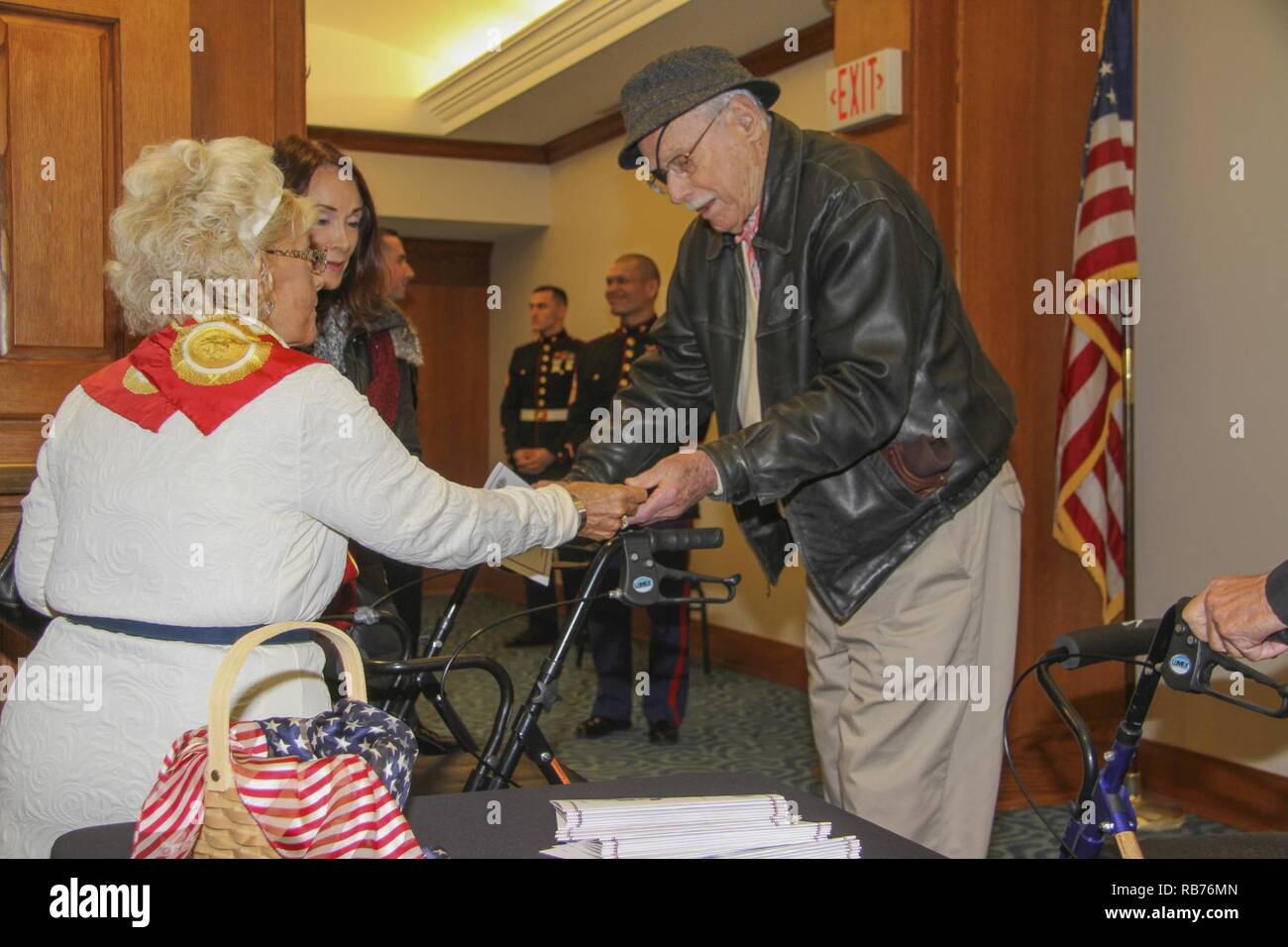 Dodie Neller, a local realtor from East Lansing, left, hands a veteran ...