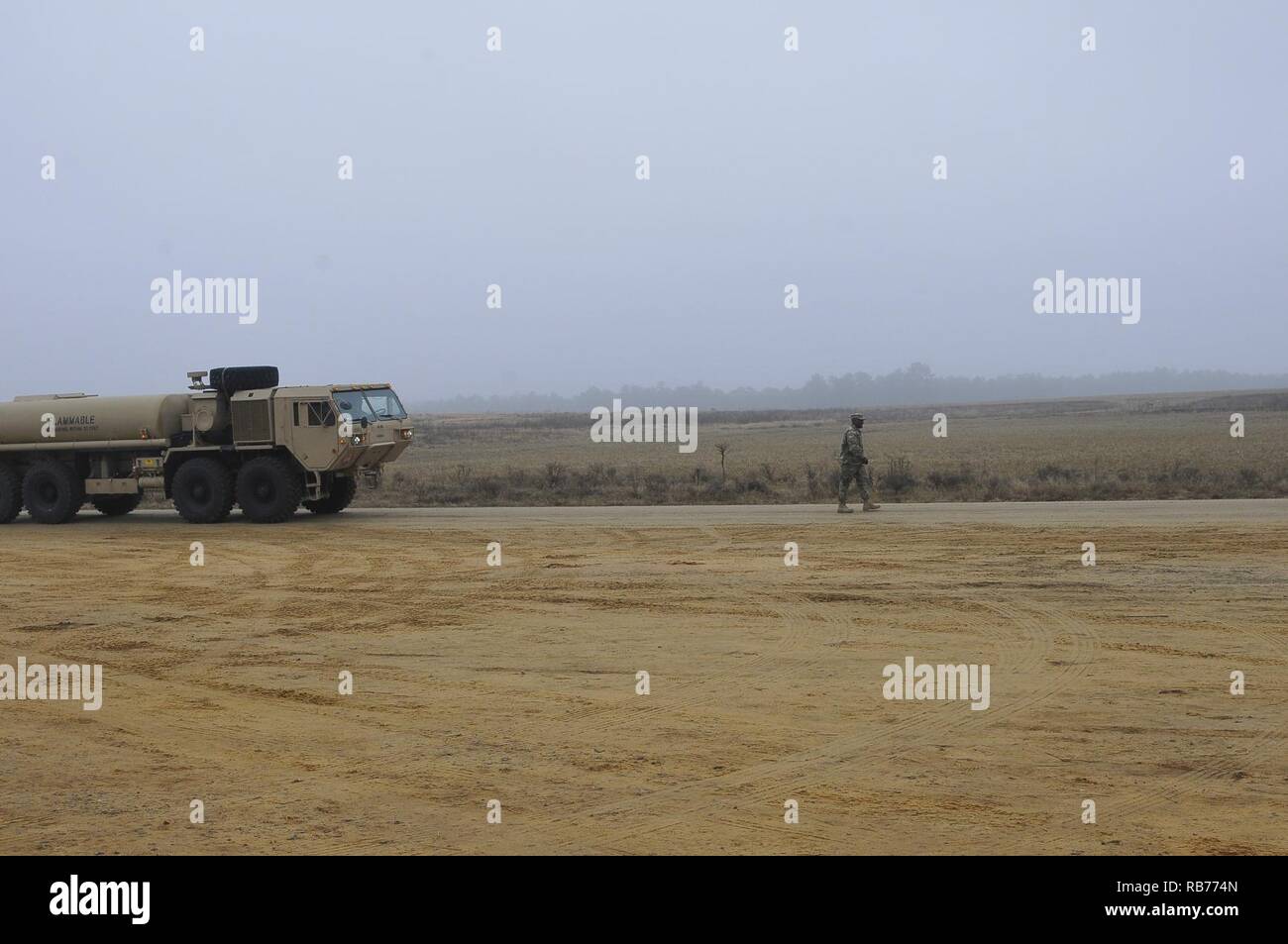 Sgt. Curtis Chambers with the 459th Transportation Company guides Spc ...