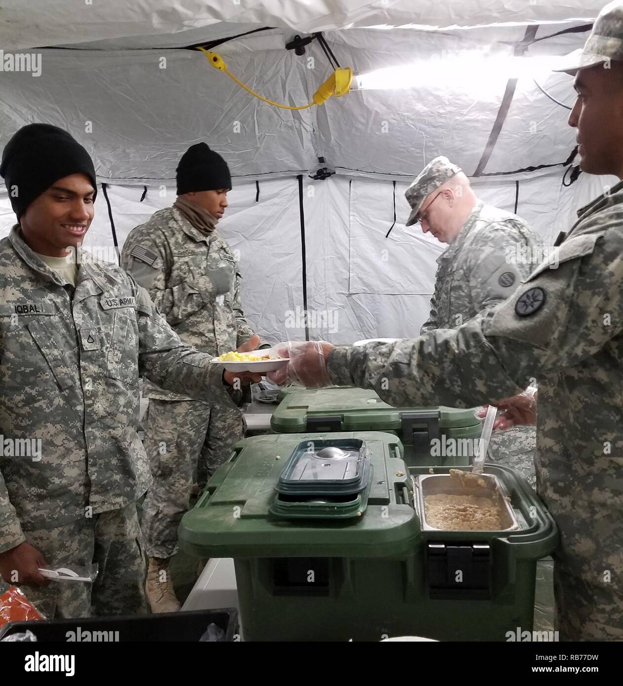 The Soldiers of a food service crew serve breakfast to Soldiers taking ...