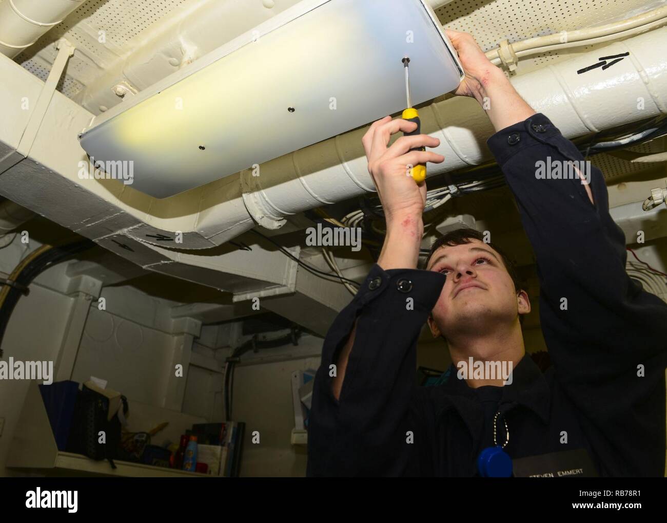 ATLANTIC OCEAN (Dec. 14, 2016) Seaman Steven Emmert changes light bulbs ...