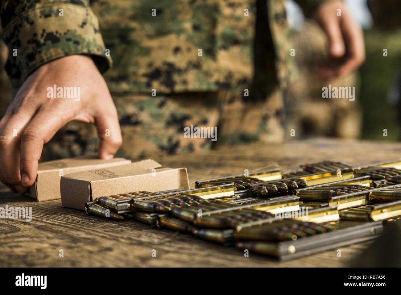Stacks of ammunition sit atop a table during a live-fire range at Camp ...