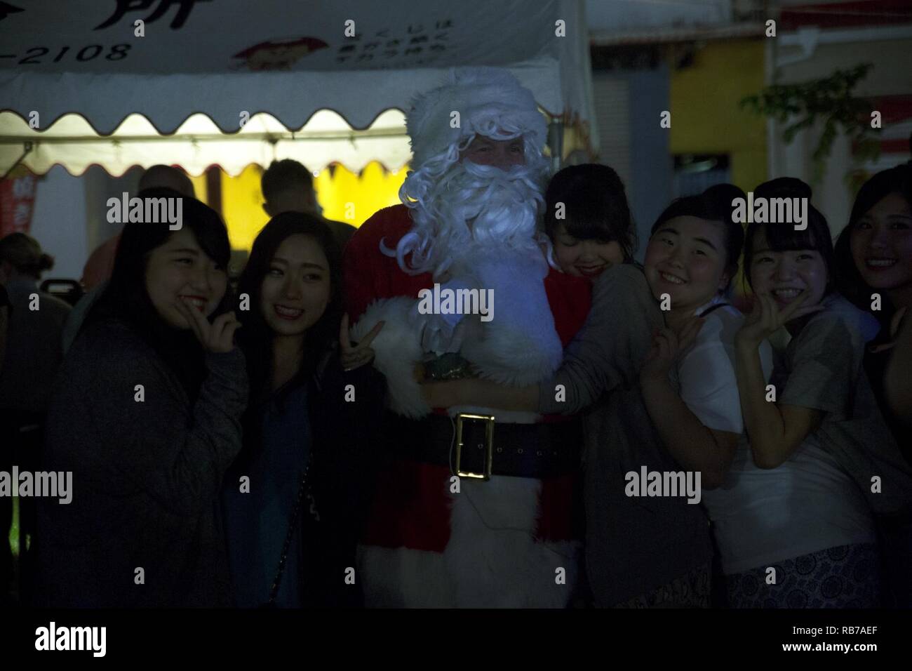 Santa takes photos with guests Dec. 1 during the Camp Hansen Tree ...