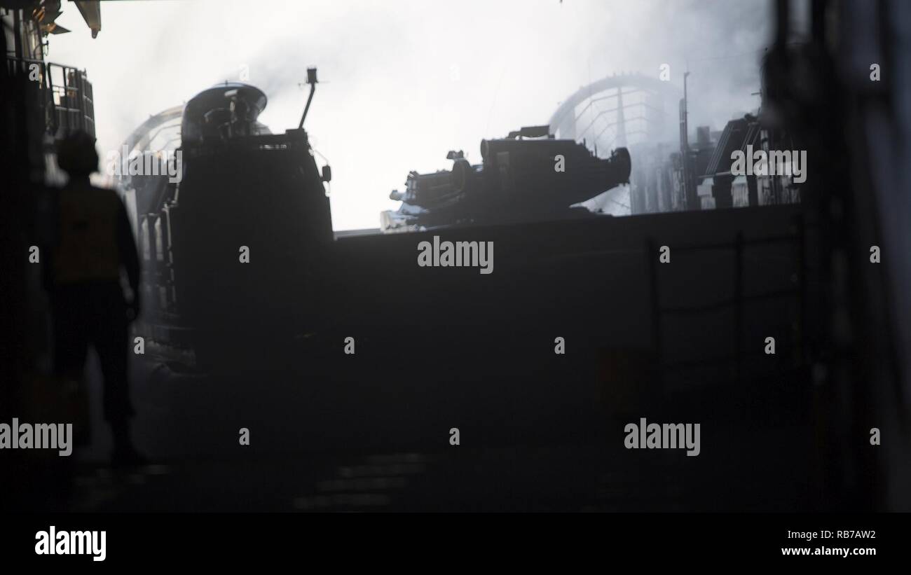 A landing craft air cushion embarks the well deck of USS Carter Hall ...