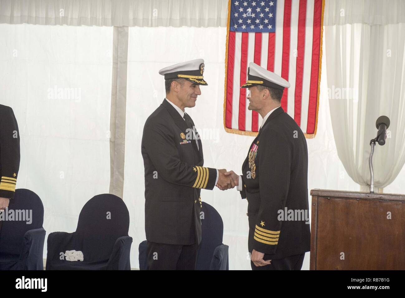GAETA, Italy (Dec. 1, 2016) – Capt. Kavon Hakimzadeh shakes hands with Capt. Carlos Sardiello ...