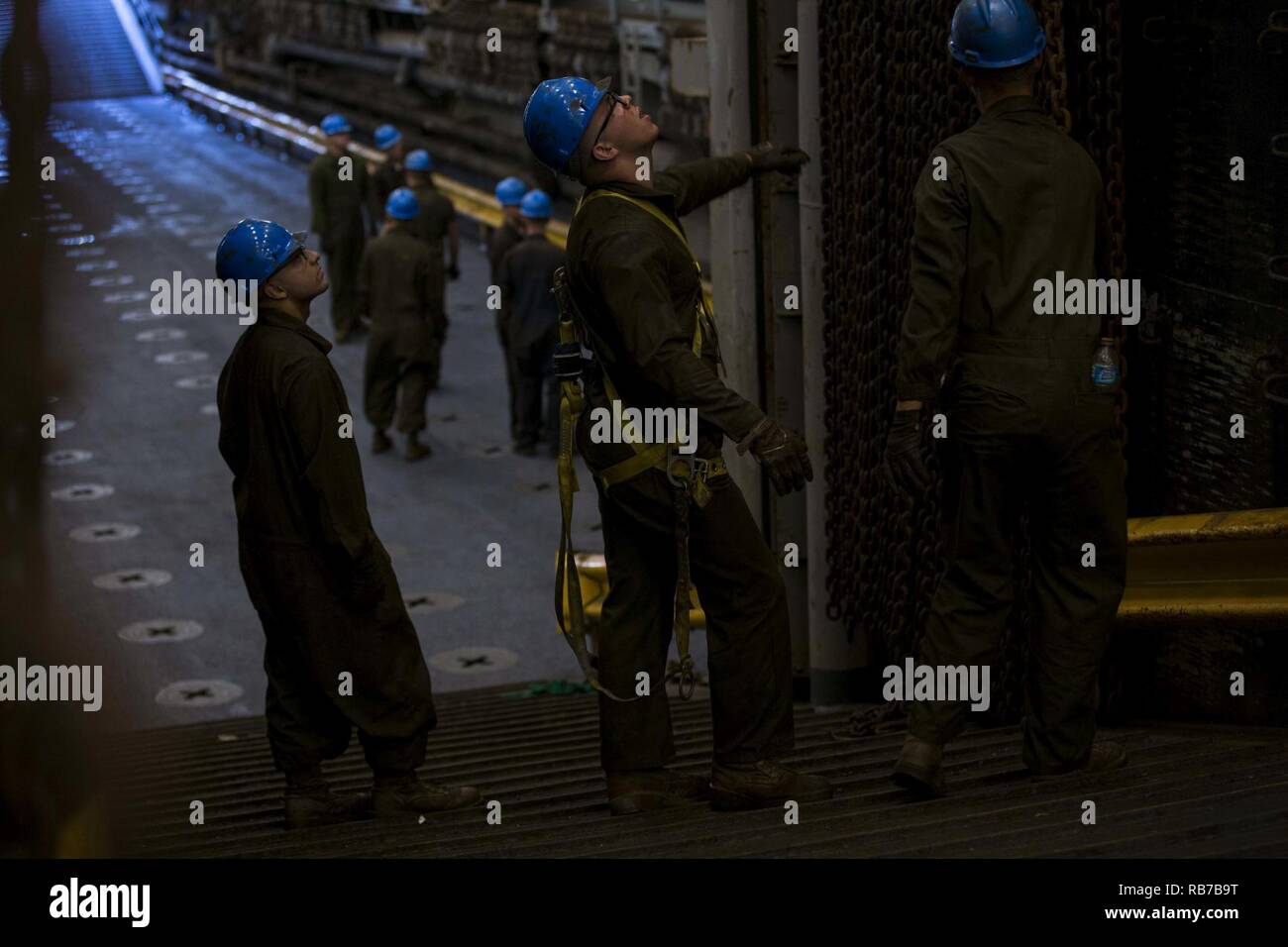 Combat Cargo Marines prepare to handle chains for securing cargo to the ...