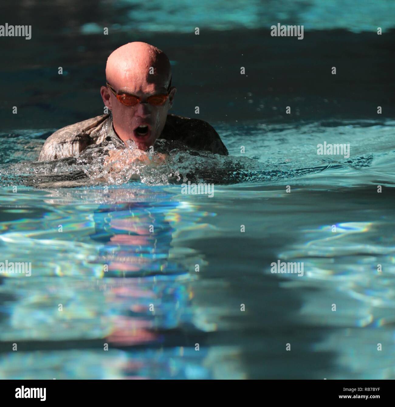 U.S. Army Maj. Paul Carlson competes in the swimming portion of the ...