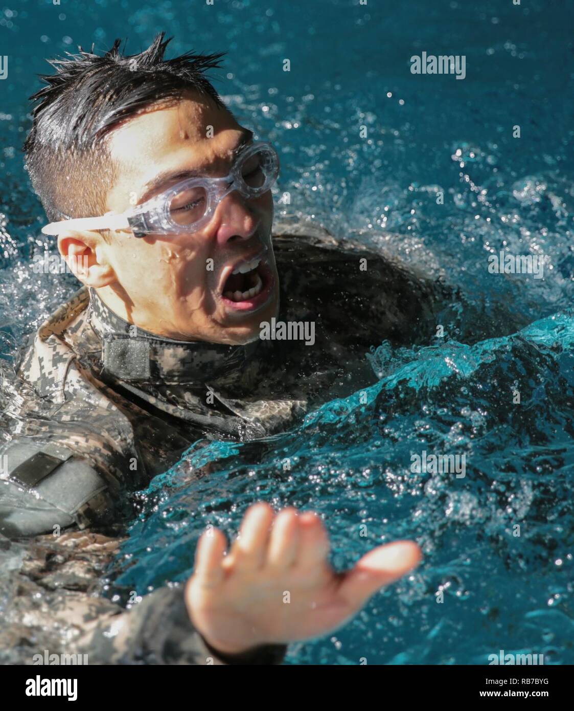 U.S. Army Capt. Austin Cheng completes a lap during the swimming event ...