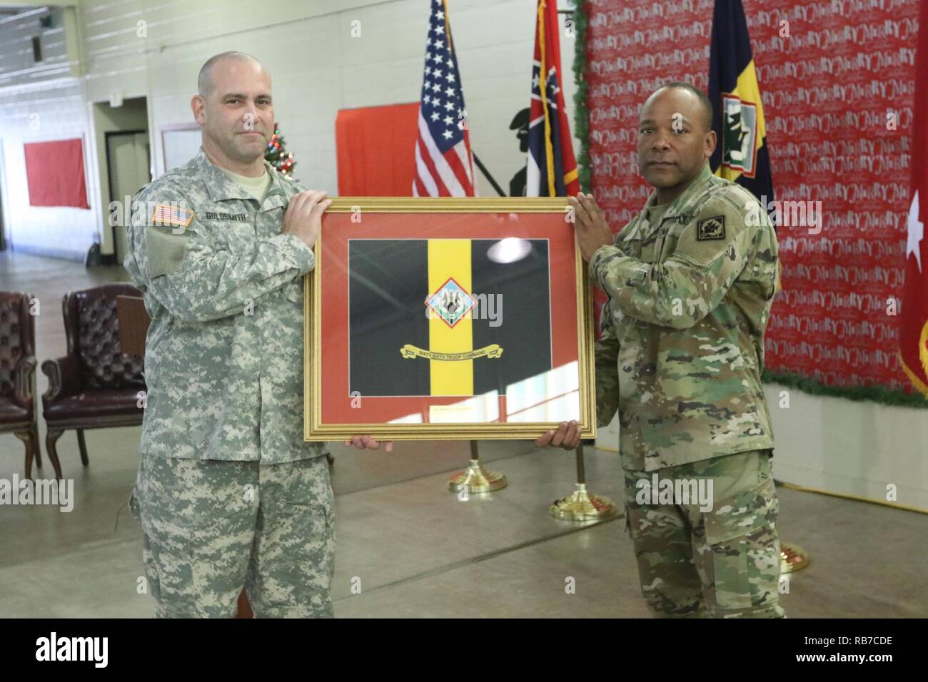 Sgt. Maj. Robert Goldsmith and Col. Rodney Harris hold up a plaque ...