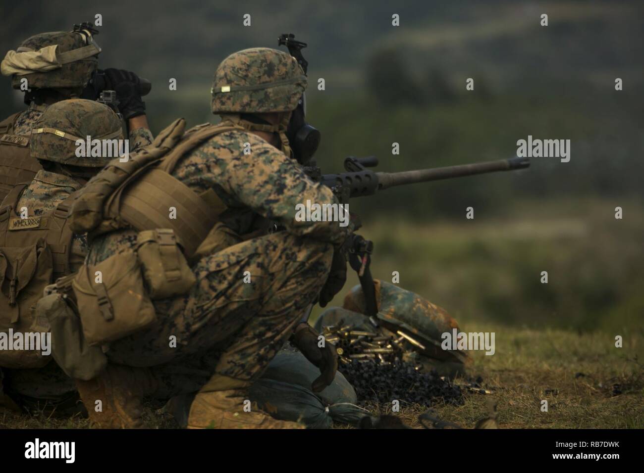 EASTERN TRAINING AREA, OKINAWA, Japan – Marines dawn their gas masks ...