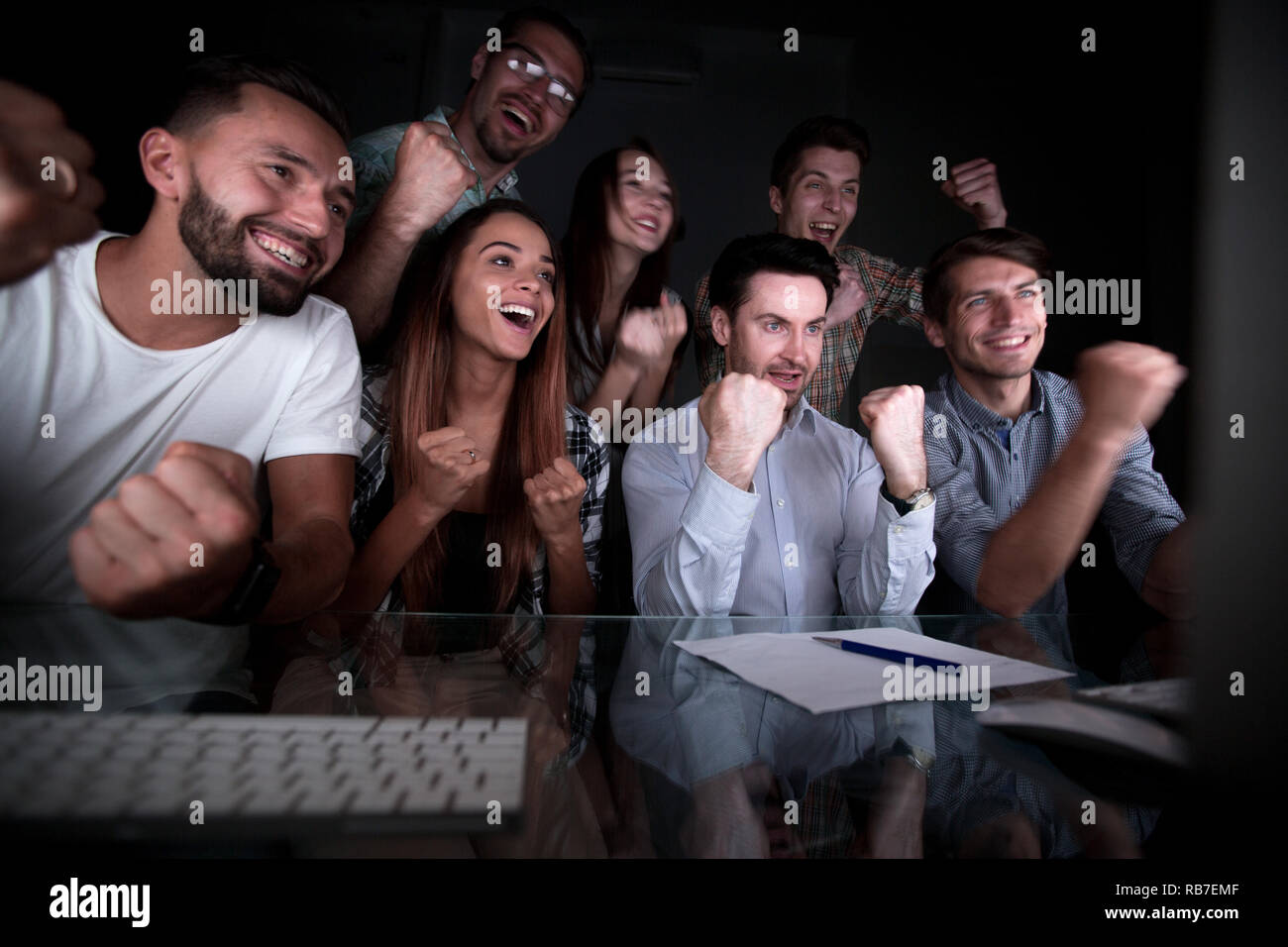 happy business team looking at computer monitor Stock Photo - Alamy