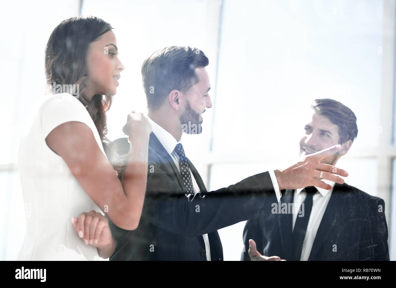 group of business people talking while standing in the office Stock ...