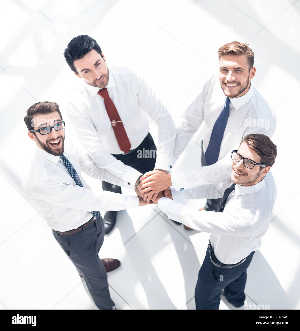 Team members putting hands hi-res stock photography and images - Alamy