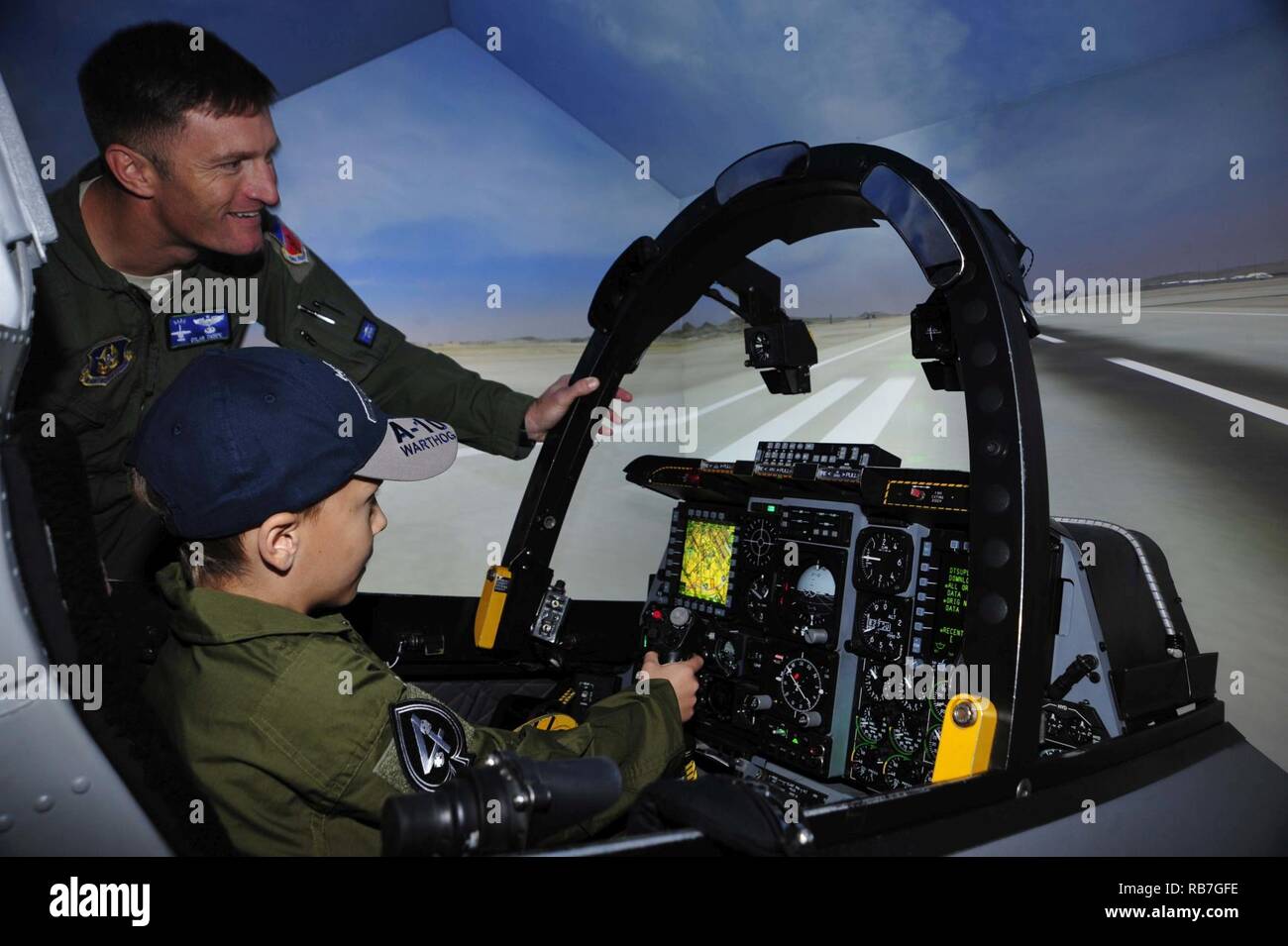 Noah Hepner, 10, is guided by Lt Colonel Dylan Thorpe, A-10C instructor ...