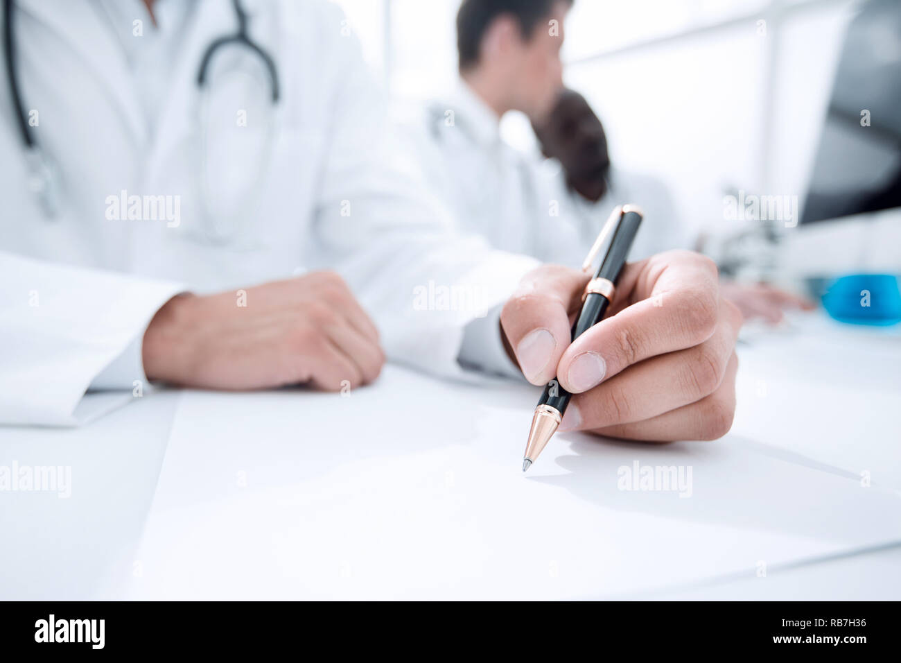 close up.doctor writing something in the lab journal Stock Photo - Alamy