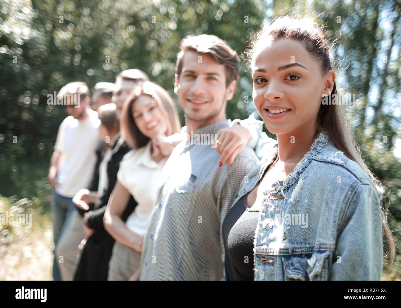 side view of a group of serious young men standing together Stock Photo ...