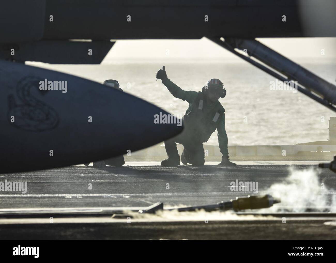 PACIFIC OCEAN (Dec. 5, 2016) Petty Officer 2nd Class Matthew Syme signals clear as an F/A-18C ...