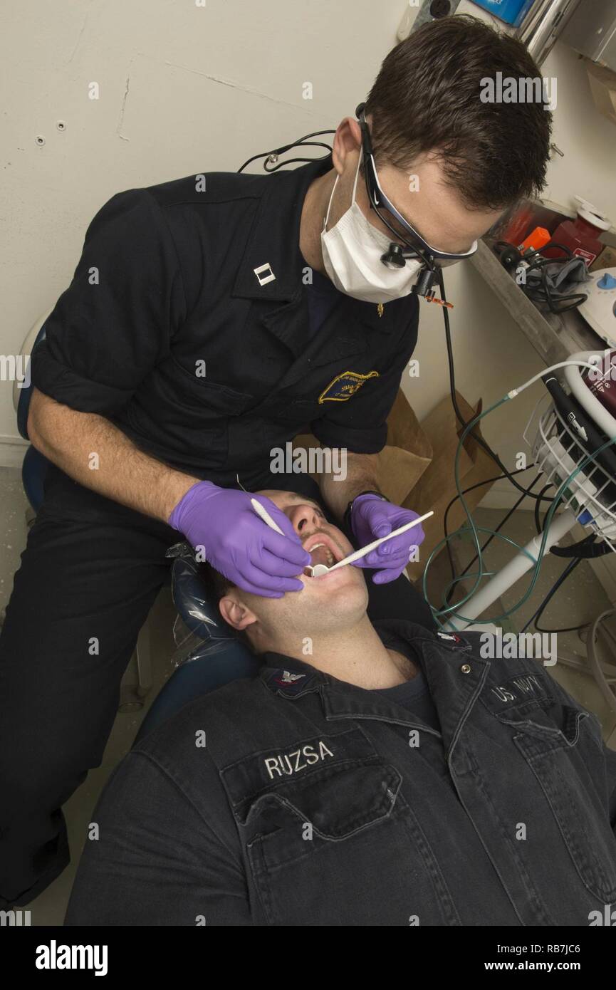 ATLANTIC OCEAN (Dec. 5, 2016) Lt. Andrew Hubbard does a dental exam on ...