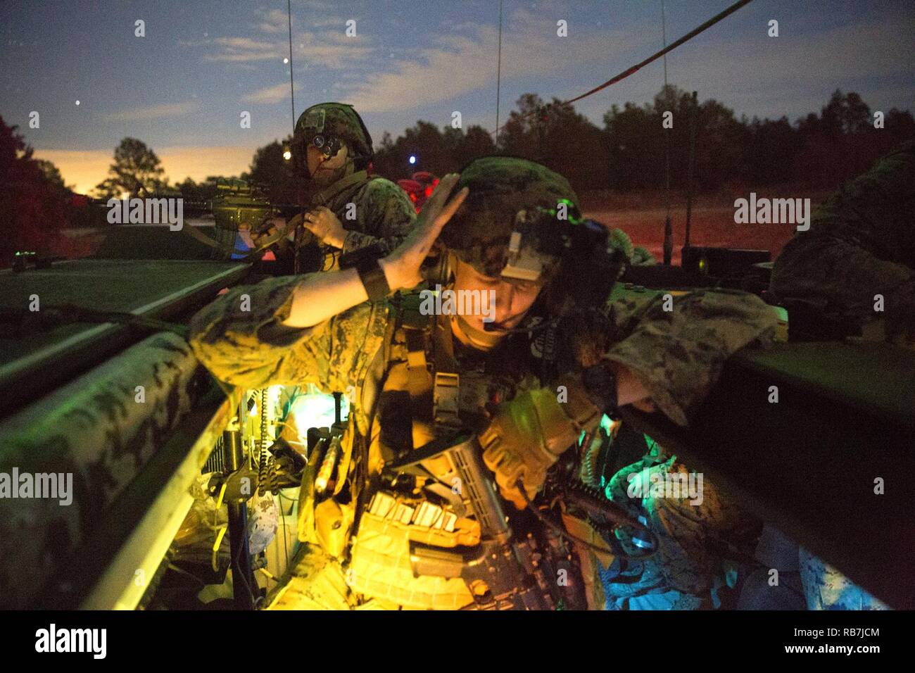 1st Lt. Nathan Cheney communicates over a radio during a mechanized ...