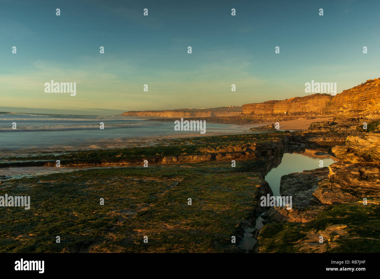 small beach with rocks and the ocean waves breaking on it Stock Photo ...
