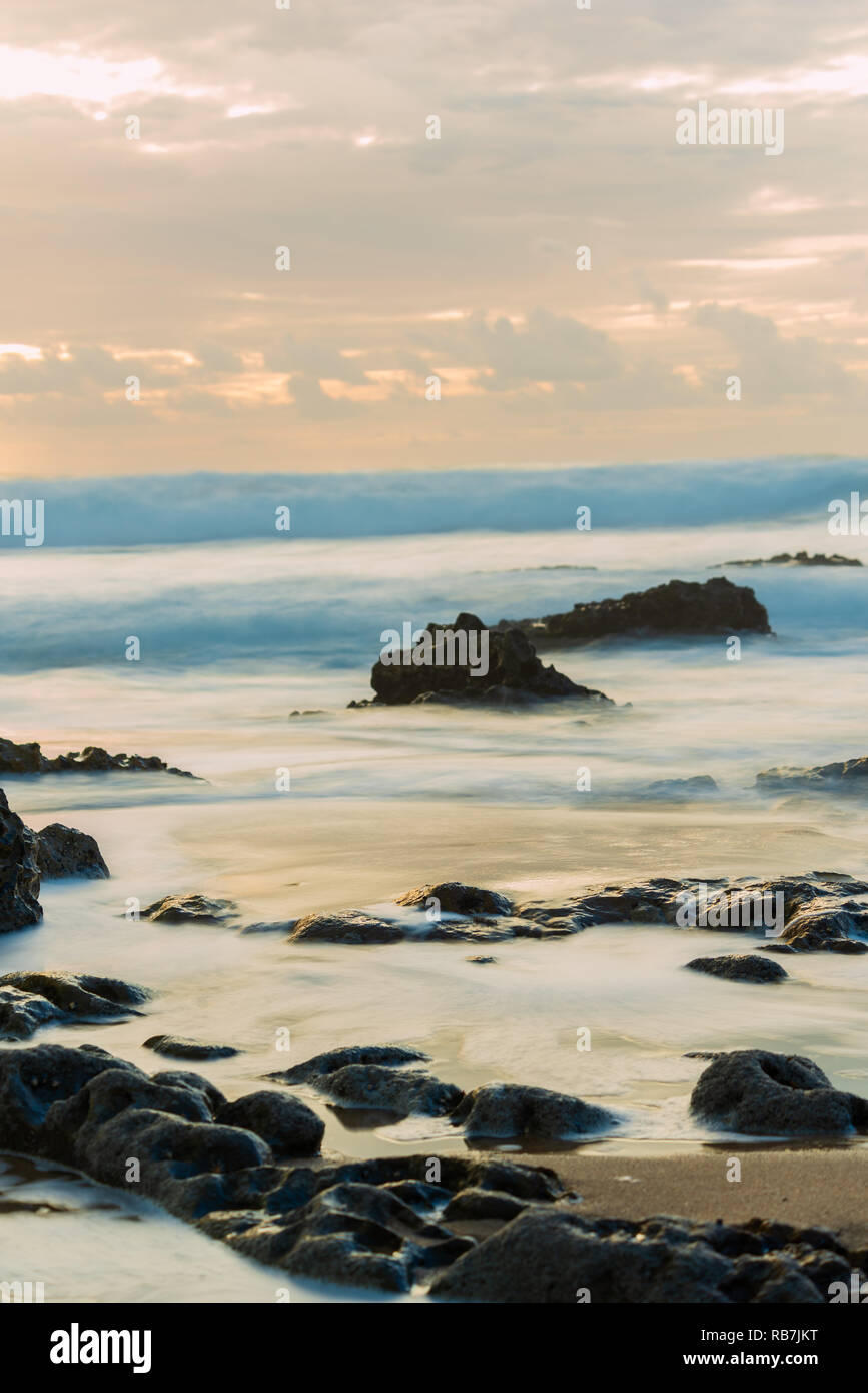 small beach with rocks and the ocean waves breaking on it Stock Photo ...