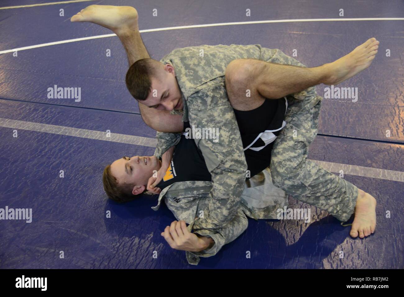 U.S. Army Staff Sgt. Sean Marshall (Instructor), sweeps his opponent ...