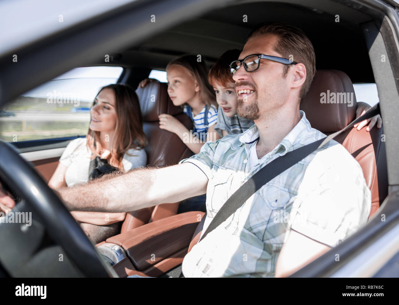 side view.happy family rides in the car Stock Photo - Alamy